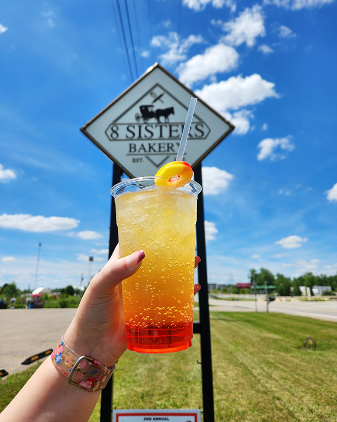 A sunshine-colored beverage against the bakery sign&mdash;proof that 8 Sisters knows refreshment doesn't stop at solid food.
