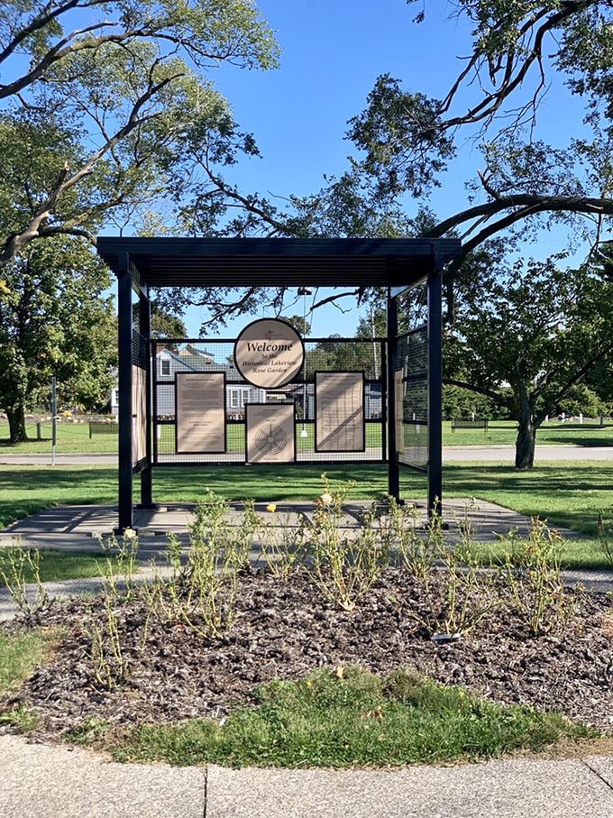 The welcome kiosk stands sentinel among shady trees, a first hello to visitors discovering this lakeside treasure.