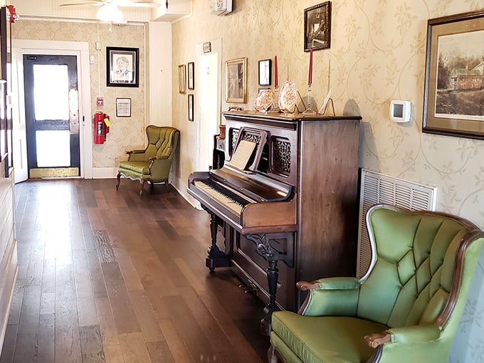 An antique piano stands ready in the hallway, as if waiting for someone to play a Southern hymn between courses.