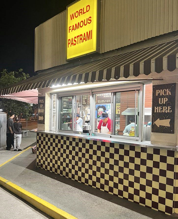 Night owls rejoice! The pickup window glows like a beacon of hope for those with late-night pastrami emergencies.