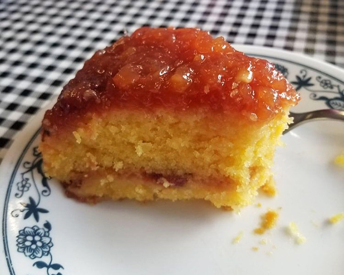 Pineapple upside-down cake that would make your grandmother both proud and jealous. Sweet, tangy perfection on a blue-rimmed plate.