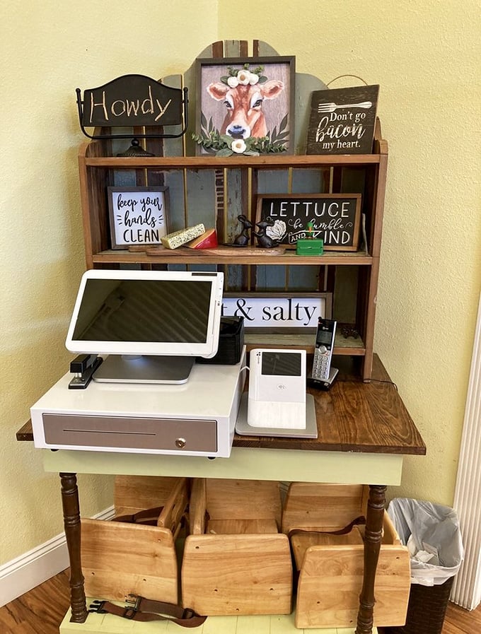 The checkout counter's rustic charm features wooden shelves adorned with playful signs, including the wisdom "Don't go bacon my heart."