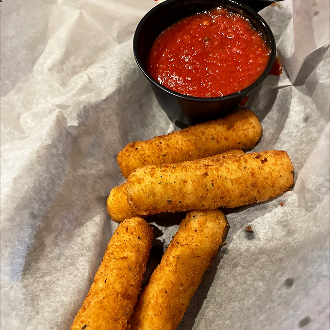 Provolone sticks: Where cheese meets deep-fryer in a crispy-on-the-outside, stretchy-on-the-inside miracle. Marinara sauce standing by for dunking duty.