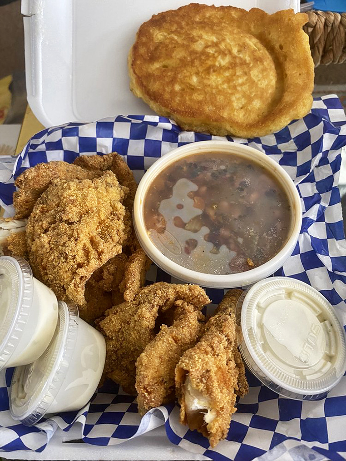 Perfectly fried fish with a cornmeal coating that crackles with each bite, paired with beans that have clearly simmered their way to perfection.
