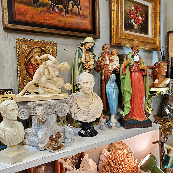 Holy collectibles, Batman! Religious artifacts mingle with classical busts in this corner where the sacred meets the scholarly.