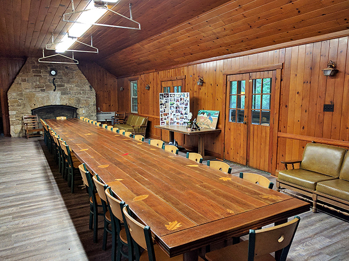 The rustic lodge interior features a massive table that's seen generations of family gatherings, camp meetings, and probably a few heated Monopoly games.
