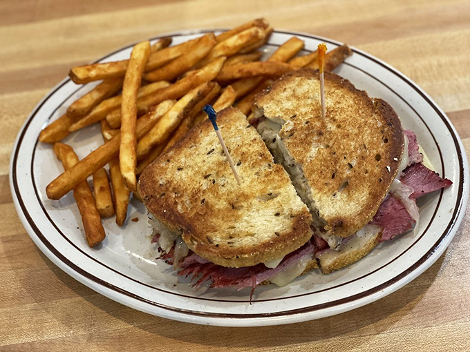 The Reuben sandwich stands tall and proud, a testament to the art of proper deli construction.