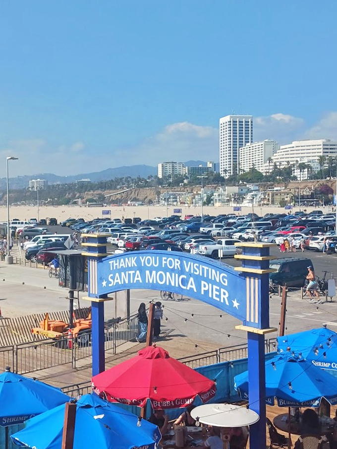 Thank you for visiting signs the pier's farewell, but colorful umbrellas and bustling parking lots prove nobody's ready to leave.