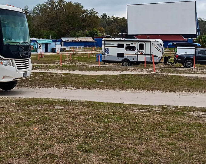 The massive screen stands ready for showtime, a blank canvas about to transport viewers to worlds far beyond the Florida grasslands surrounding it.