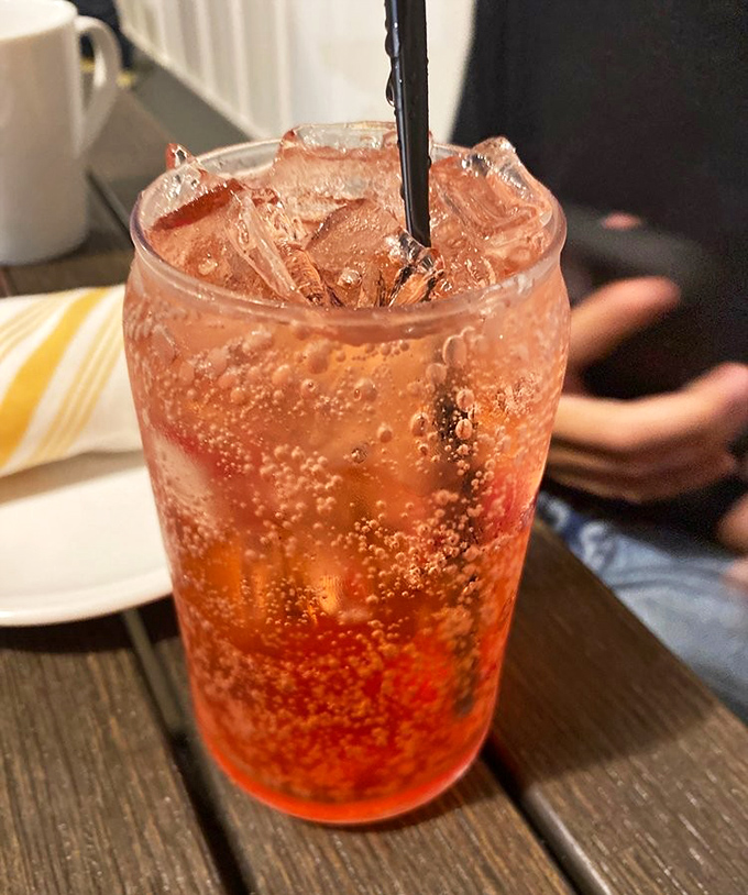 A fizzy, coral-colored mocktail that proves non-alcoholic drinks don't have to sit at the kids' table when it comes to sophistication.