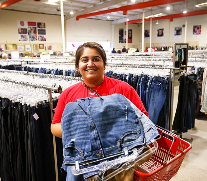 Success! A shopper's smile says it all as she discovers the perfect pair of jeans among thousands&mdash;the universal thrift store victory pose.