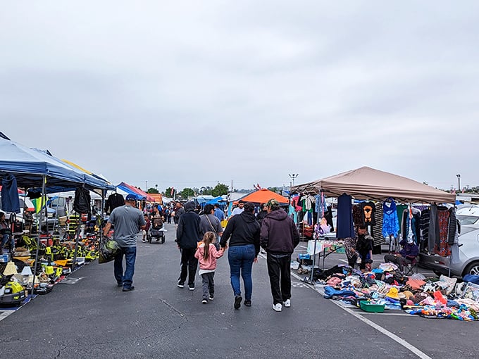 Family shopping expedition through the maze of merchandise. The swap meet transforms ordinary weekend errands into a multi-generational treasure hunt.