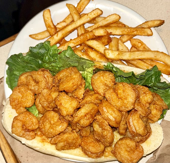 This isn't just a shrimp po'boy&mdash;it's a celebration of the Gulf's bounty on a bun. Golden crustaceans piled high enough to require strategic eating.