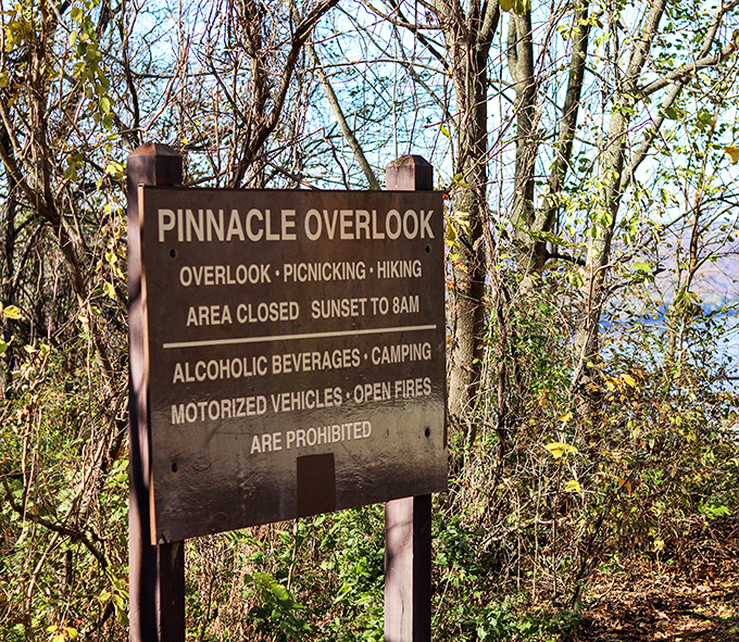 The sign says it all&mdash;paradise has operating hours. Pinnacle Overlook welcomes daytime adventurers while preserving the night for wildlife and stargazers.