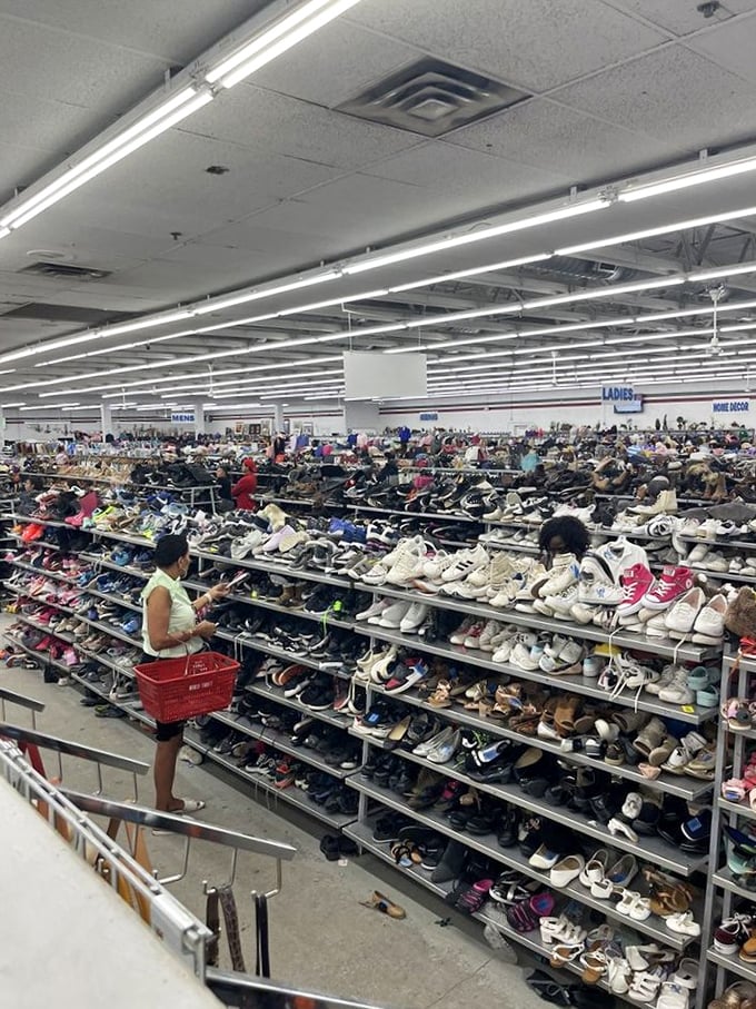 Shoppers navigate the vast expanse with purpose and determination. This isn't shopping &ndash; it's a competitive sport with bargains as trophies.