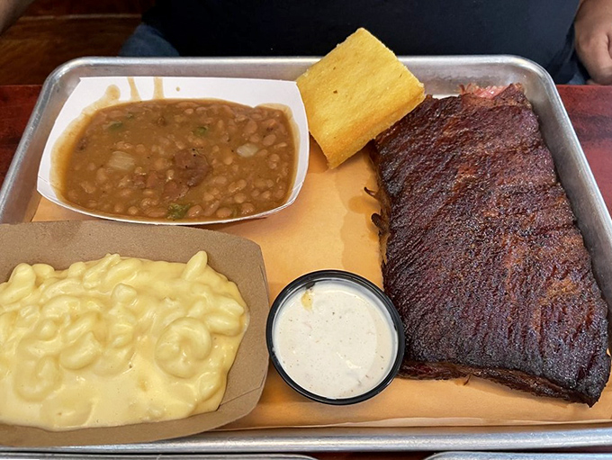 Baked beans, mac and cheese, and ribs with a bark so perfect it should be hanging in a barbecue museum.