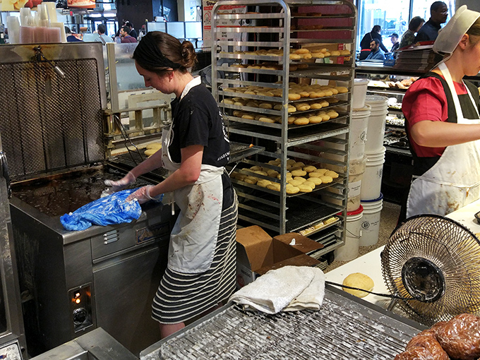 Staff members work with hypnotic efficiency, their hands performing a donut ballet that's been perfected through generations of practice.
