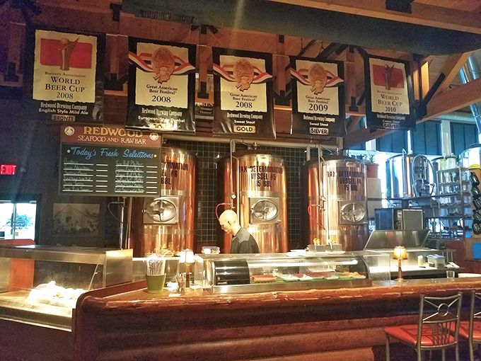 Award banners proudly displayed above the brewing equipment tell the story of passion translated into medal-winning craft beers.