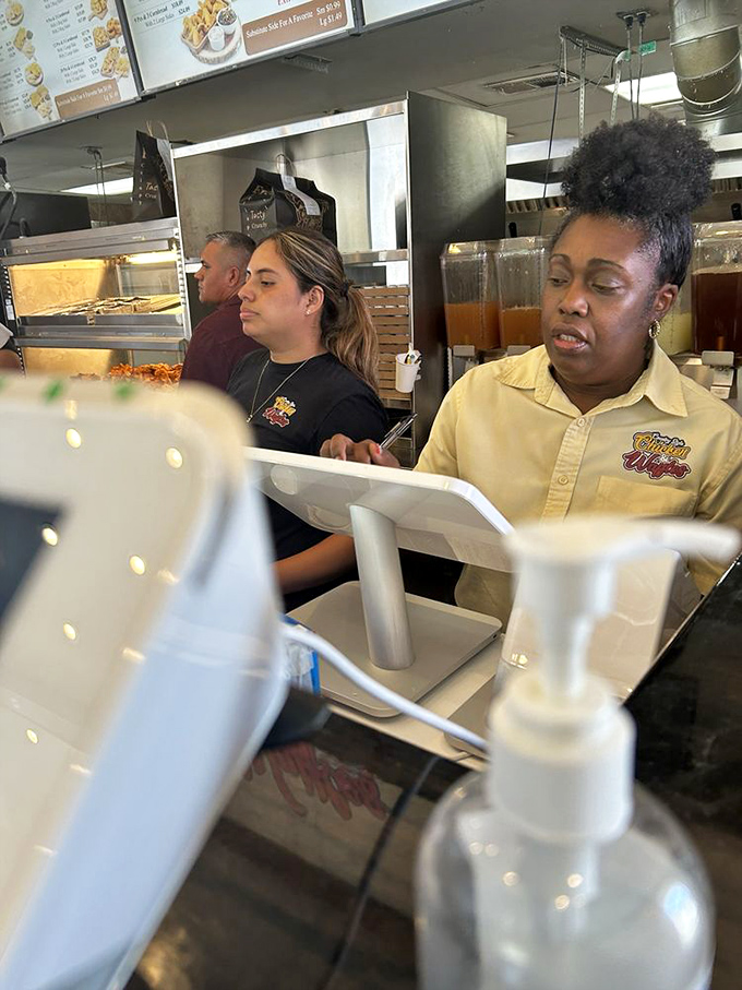 The dedicated team making your chicken dreams come true. Their focused expressions say everything about their commitment to perfection.