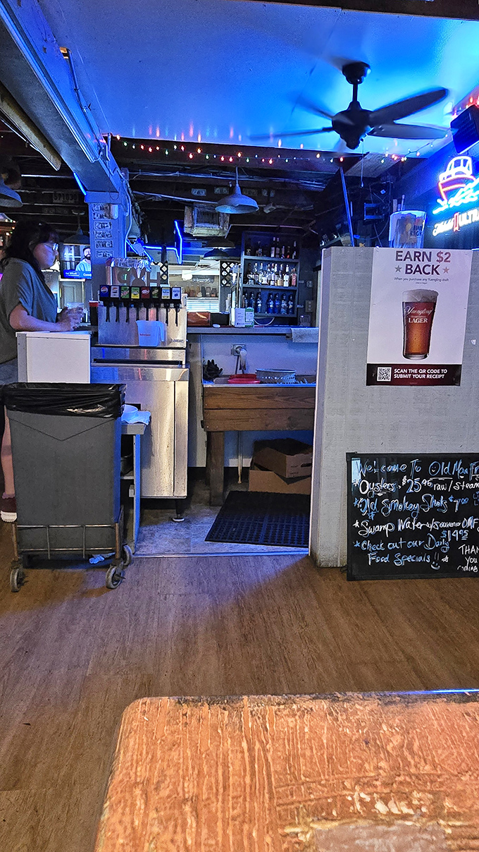 The blue glow of the bar area isn't just mood lighting&mdash;it's the backdrop for liquid refreshment that flows as steadily as the conversations around it. 