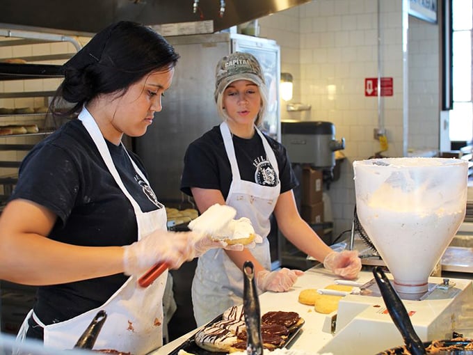 Artisans at work. These aren't just bakers&mdash;they're happiness engineers constructing edible joy one donut at a time.