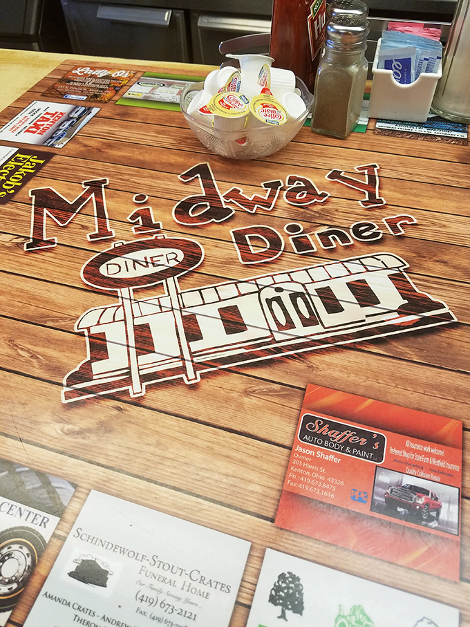 The tabletop tells the story of a community. Each business card and advertisement represents a neighbor supporting another neighbor.