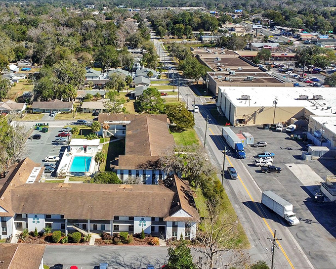 This aerial view of apartment living shows why retirees flock to Ocala&mdash;affordable housing arranged around water features that rival resort amenities. 