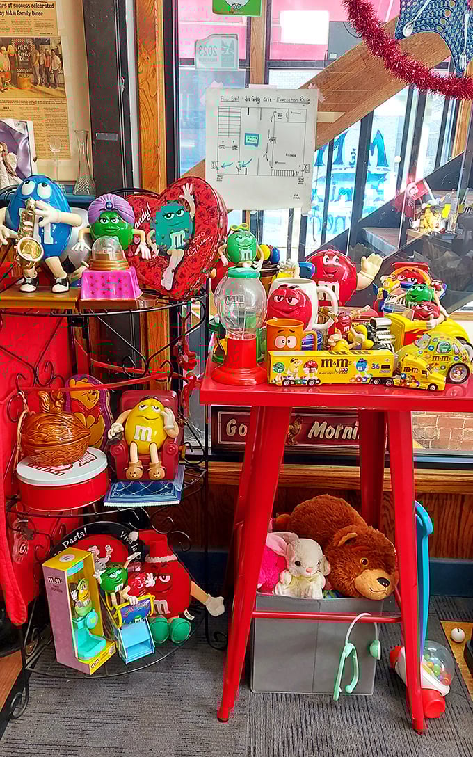 M&M collectibles guard the entrance like colorful sentinels. This whimsical collection explains the diner's name in the sweetest possible way.