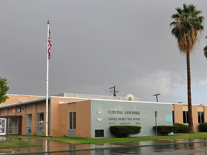 Even rain looks different in Blythe. The Federal Building stands stoically against rare desert showers, a reminder of small-town civic pride.