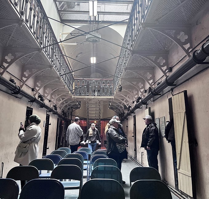 Tour groups stand where inmates once gathered, temporary visitors in a place where others counted years by the changing seasons outside.