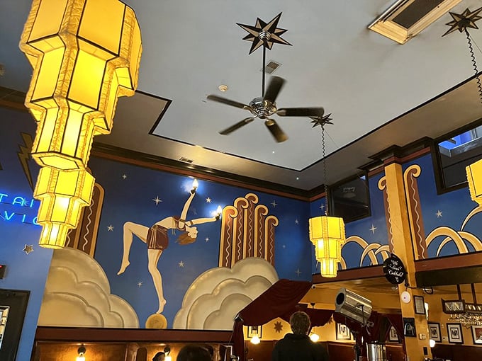 The ceiling stars and Art Deco murals create dining theater. Like eating inside a Jazz Age dream sequence directed by Wes Anderson.