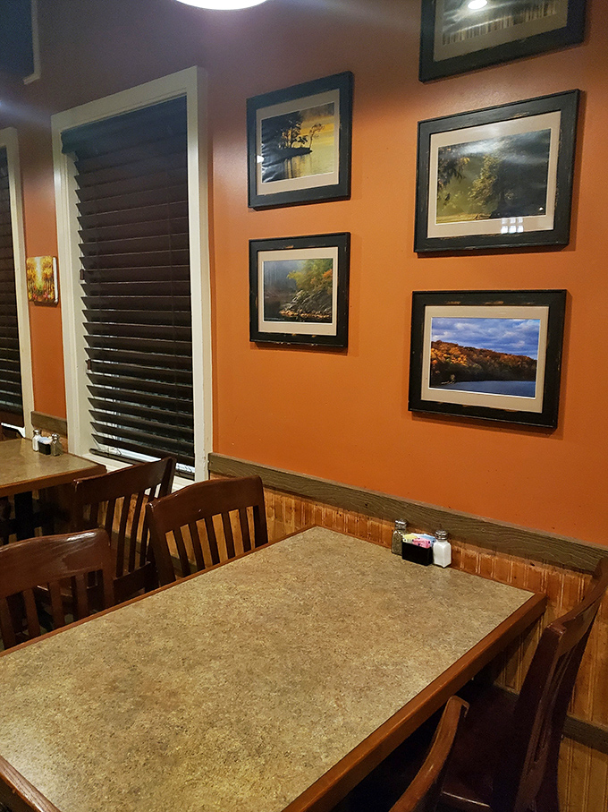 The dining room's warm orange walls adorned with framed landscapes create a cozy backdrop for countless birthday celebrations, first dates, and "just because" dinners.