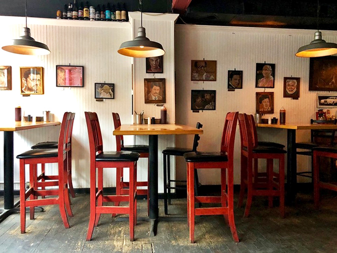 Red chairs stand at attention beneath vintage-inspired lighting, like a retro diner that got its PhD in BBQ aesthetics.