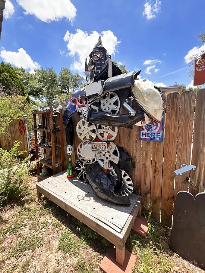 This sentinel of hubcaps and car parts stands as the unofficial greeter, a metallic transformer that forgot to transform all the way back.