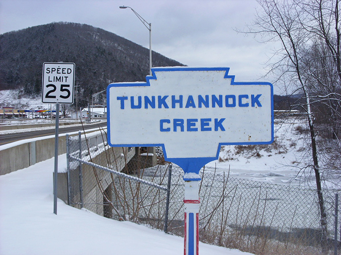 Winter blankets Tunkhannock Creek in serene white, creating a landscape that makes even the most dedicated summer enthusiasts reconsider their seasonal allegiance.
