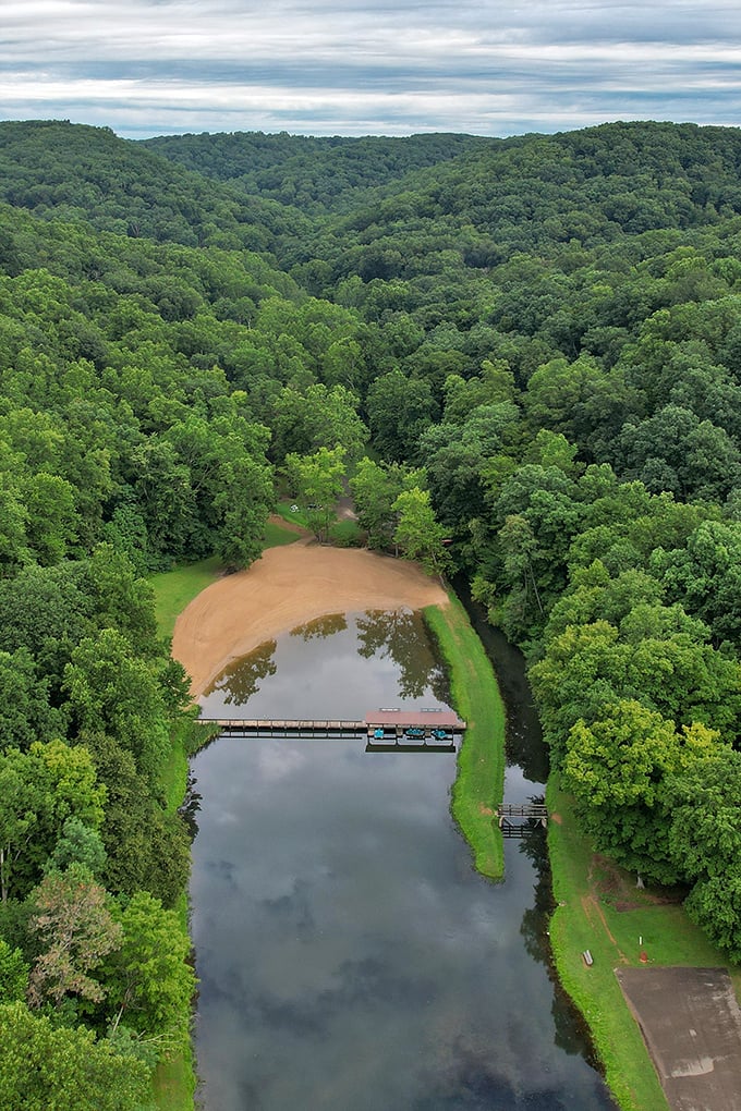 Nature's amphitheater from above! This bird's-eye view reveals Pine Lake cradled by endless forest, a blue jewel in a sea of green.