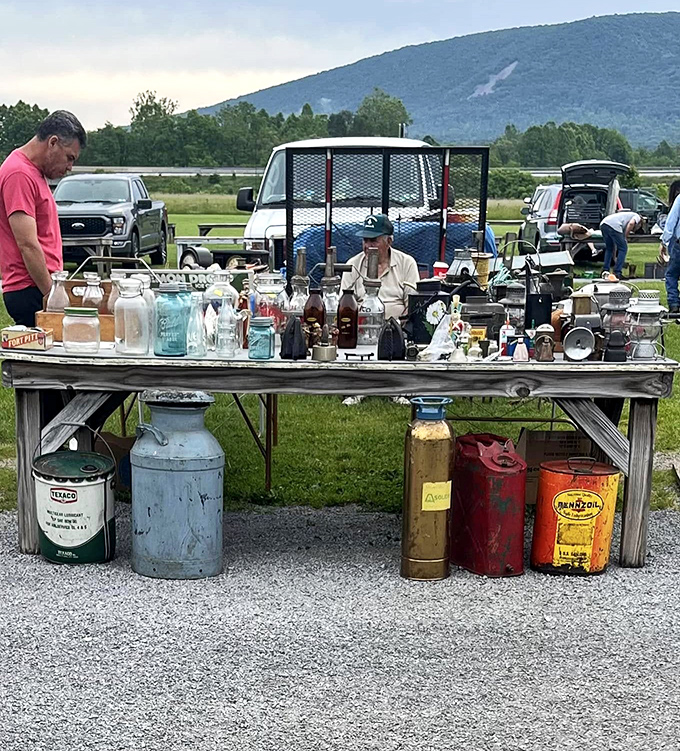 Vintage bottles and colorful gas cans create a museum of everyday Americana against the backdrop of Pennsylvania's rolling hills.
