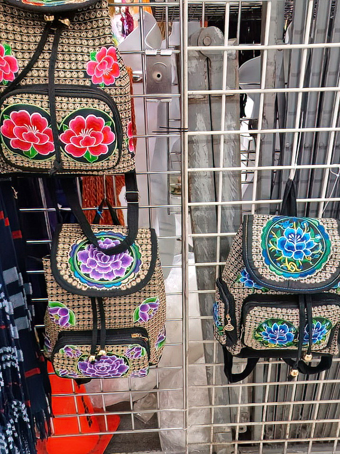 Embroidered backpacks and bags bloom with floral designs more vibrant than any garden. Practical art for everyday adventures.