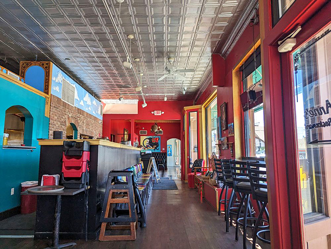 Colorful walls, tin ceiling, and an atmosphere that says "stay awhile." The decor is as vibrant as the food is flavorful.