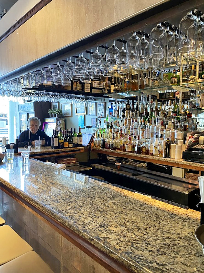 A bar that means business, with glasses hanging like crystal stalactites. The kind of setup that says, "Your Bloody Mary is in good hands."
