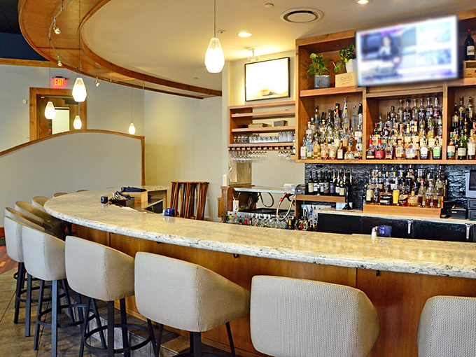 The curved bar invites you to settle in for a pre-dinner cocktail or post-meal nightcap&mdash;either way, you're not rushing home.