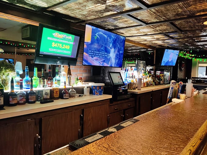 The welcoming bar area where strangers become friends over exceptional food and cold drinks.