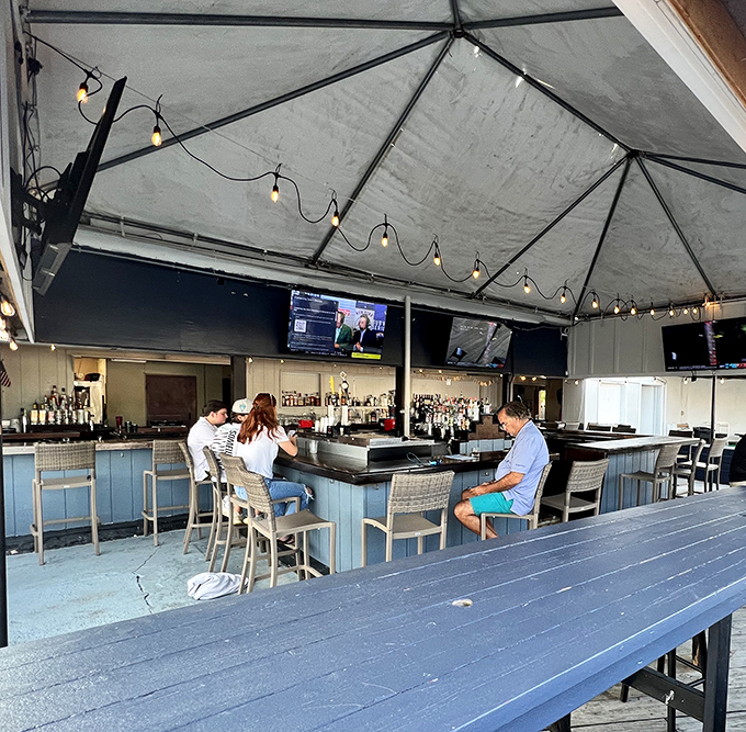 The outdoor bar offers waterfront views and cold drinks, perfect for watching boats drift by lazily.