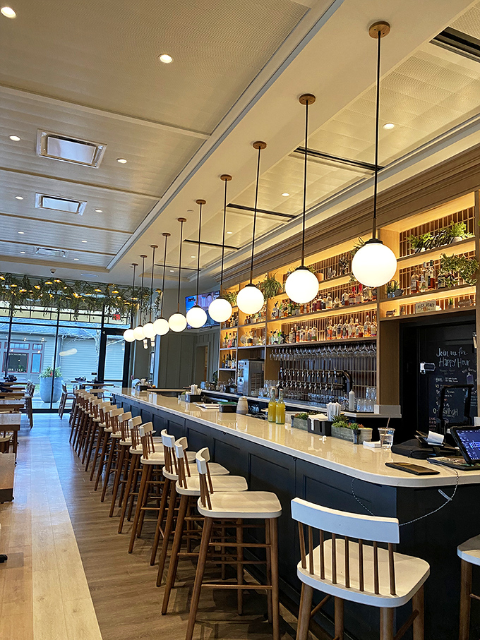 The bar stretches like a runway, with pendant lights marching in formation above. It's not just a place to drink&mdash;it's theater for the cocktail arts. 
