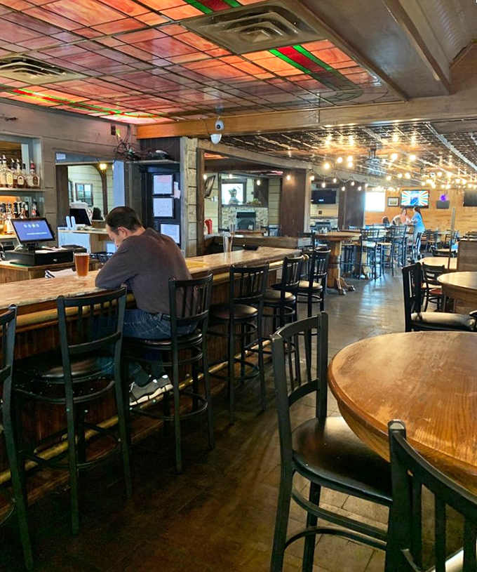 The bar area glows with warm lighting and conversation, where strangers become friends over shared plates and local stories.