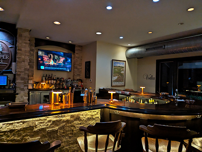 The bar glows with amber warmth, promising craft cocktails and conversations that flow as smoothly as the Wisconsin old fashioneds they serve.