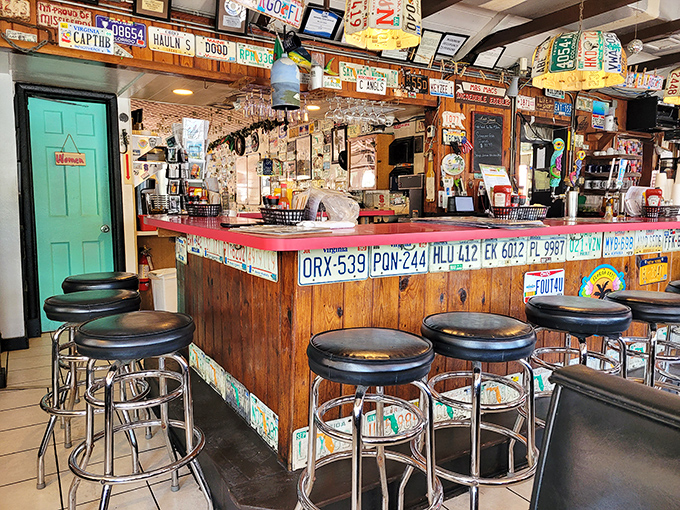 The counter where magic happens&mdash;surrounded by enough license plates to start a small DMV branch in paradise. 