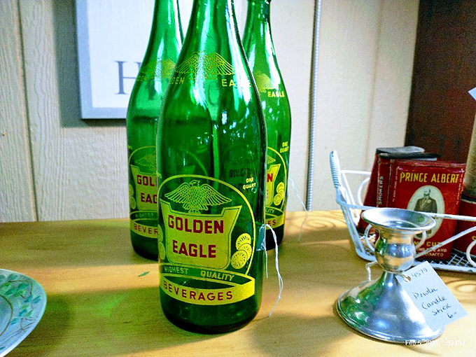 Vintage Golden Eagle soda bottles gleam with emerald nostalgia. Before plastic took over, beverages came in these substantial glass time capsules.
