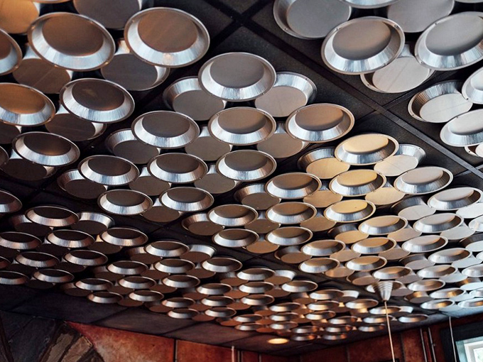 That charming tin ceiling adds vintage character, creating the perfect backdrop for timeless American comfort food traditions.