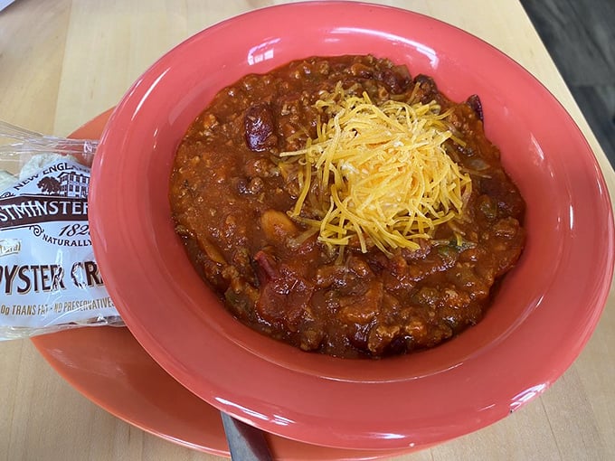 Chili that looks like it simmered since yesterday, topped with a crown of cheddar. The oyster crackers stand ready for their supporting role.